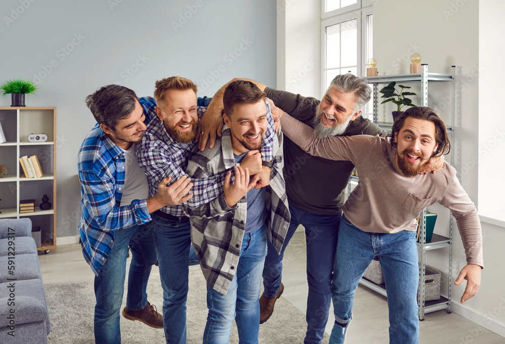 Group of joyful, smiling, excited men meeting at home, congratulating ...