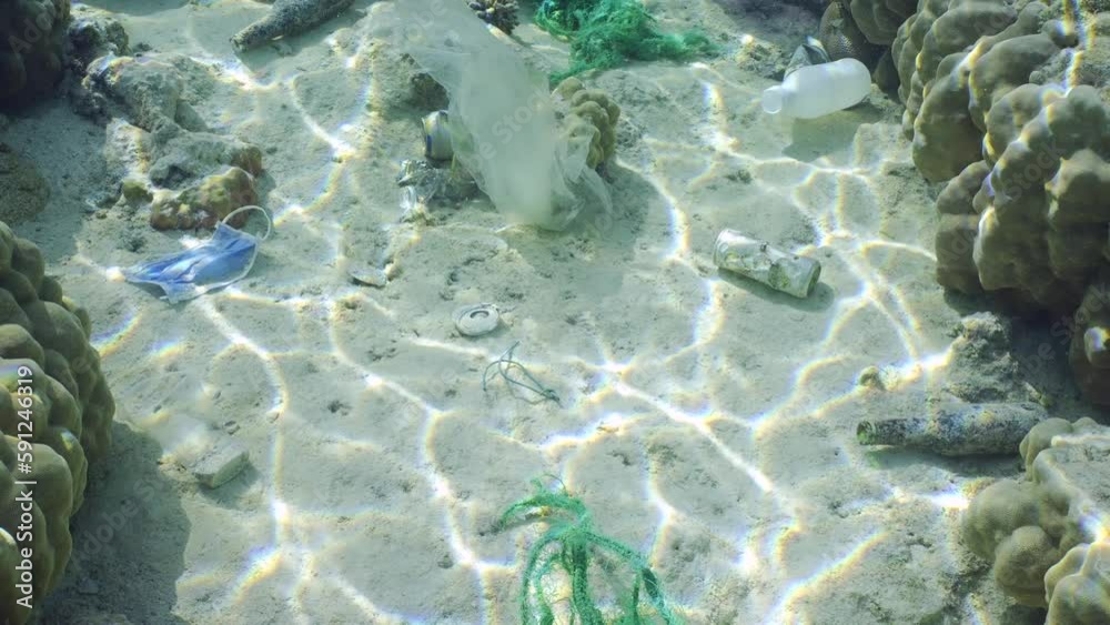 Top view of plastic pollution on beautiful shallow coral reef, Slow ...