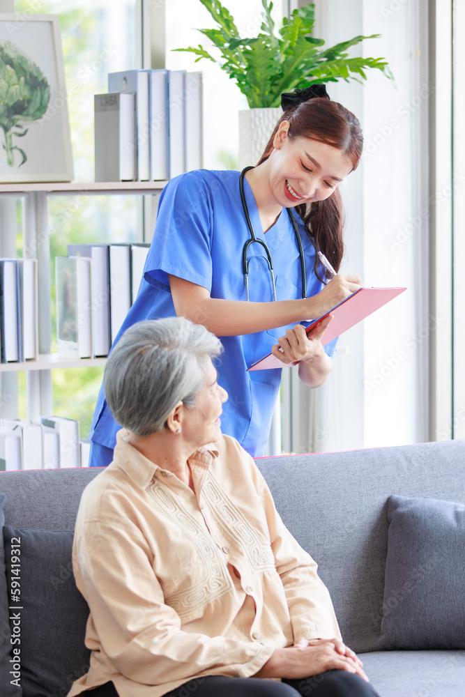Asian professional successful female intern nurse in blue uniform with ...