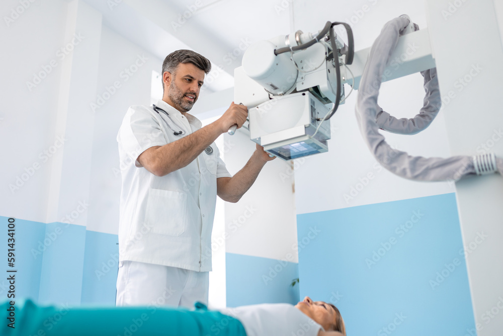 Multiethnic radiologists with young female patient in x-ray room ...