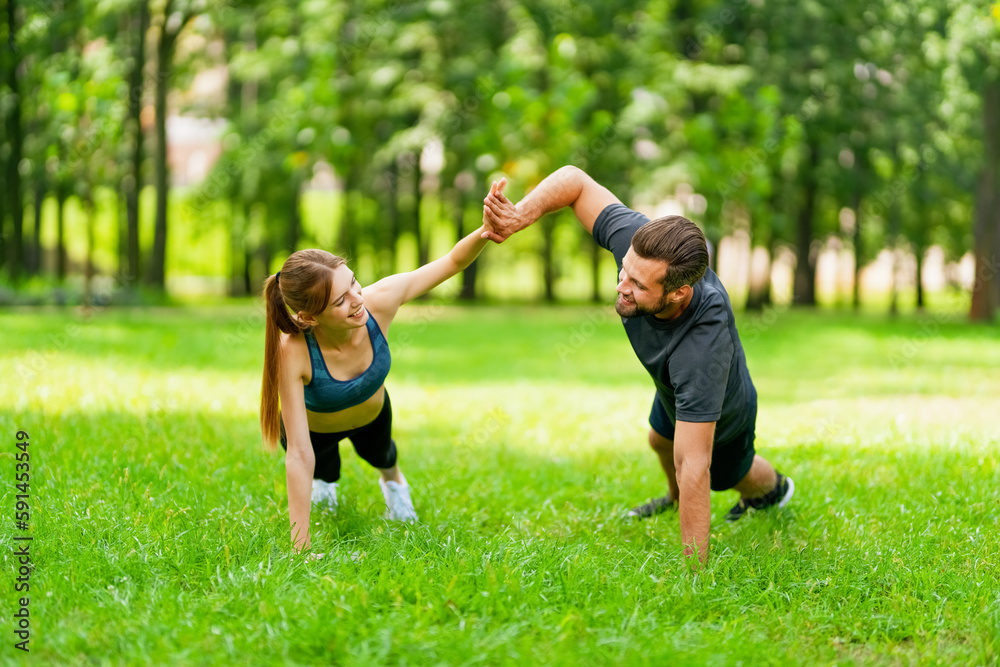 Image of young smiling couple, woman training with man or bearded coach ...