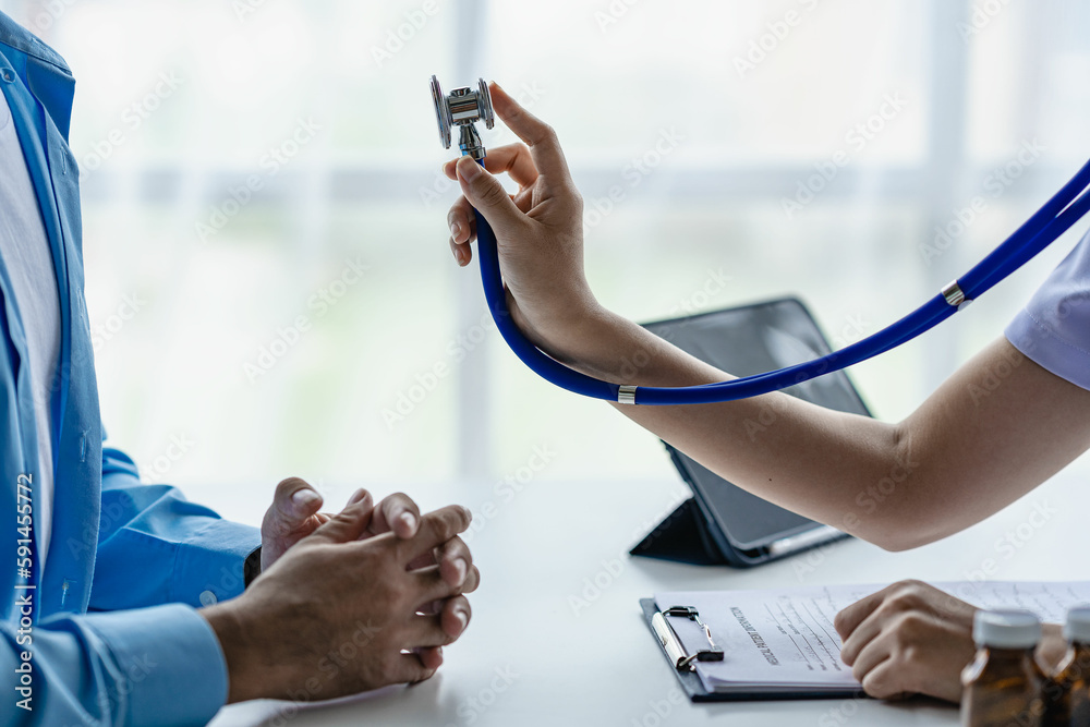 Foto Stock Male doctor caring for patient holding stethoscope listening ...