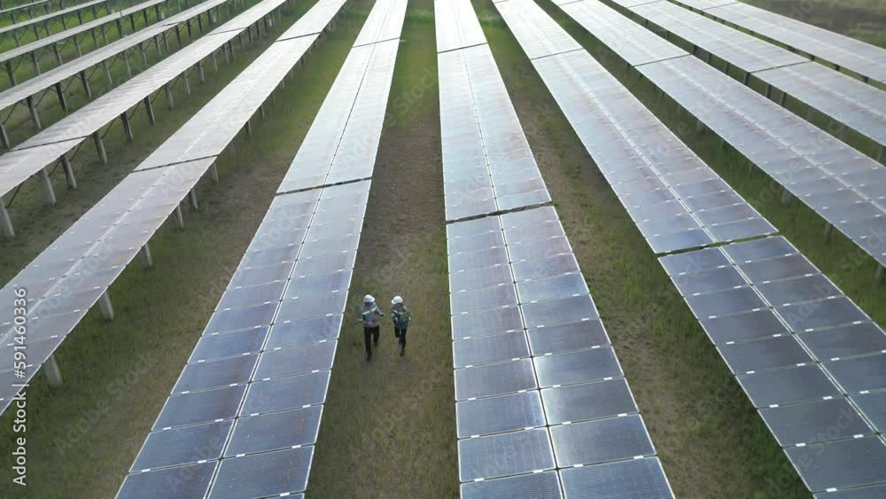 Top aerial view of Engineers checking a Solar Panels and walking in ...