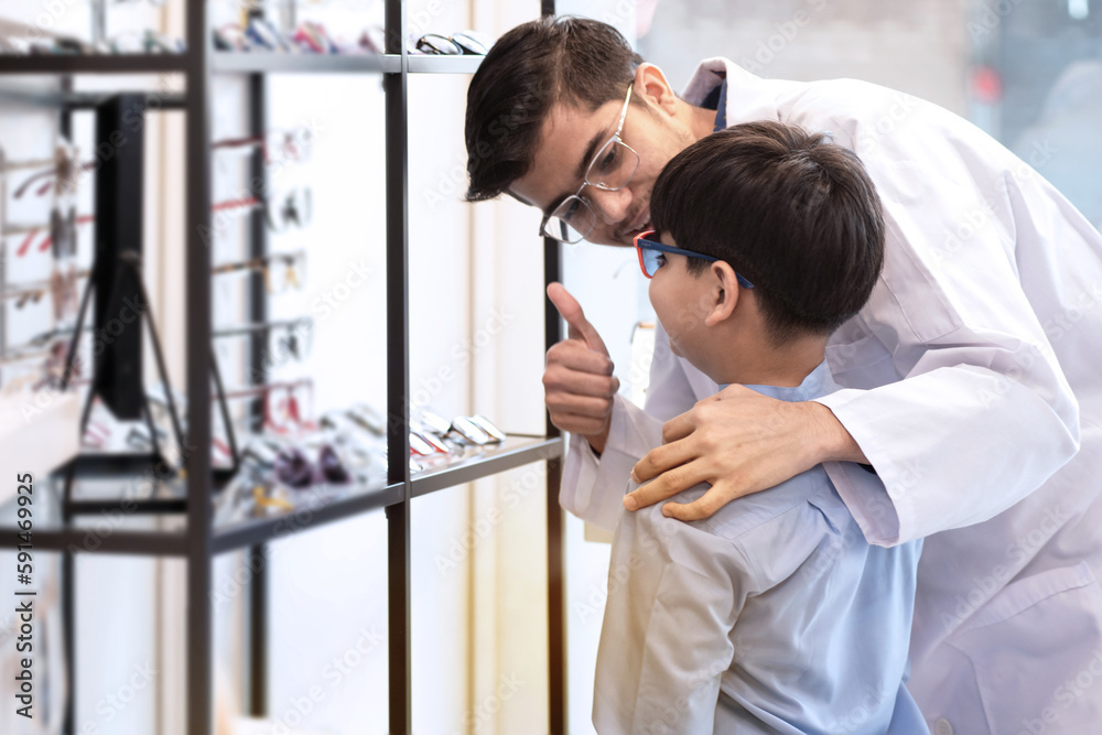 Indian child boy trying out new eyeglasses with expert advice, and man ...
