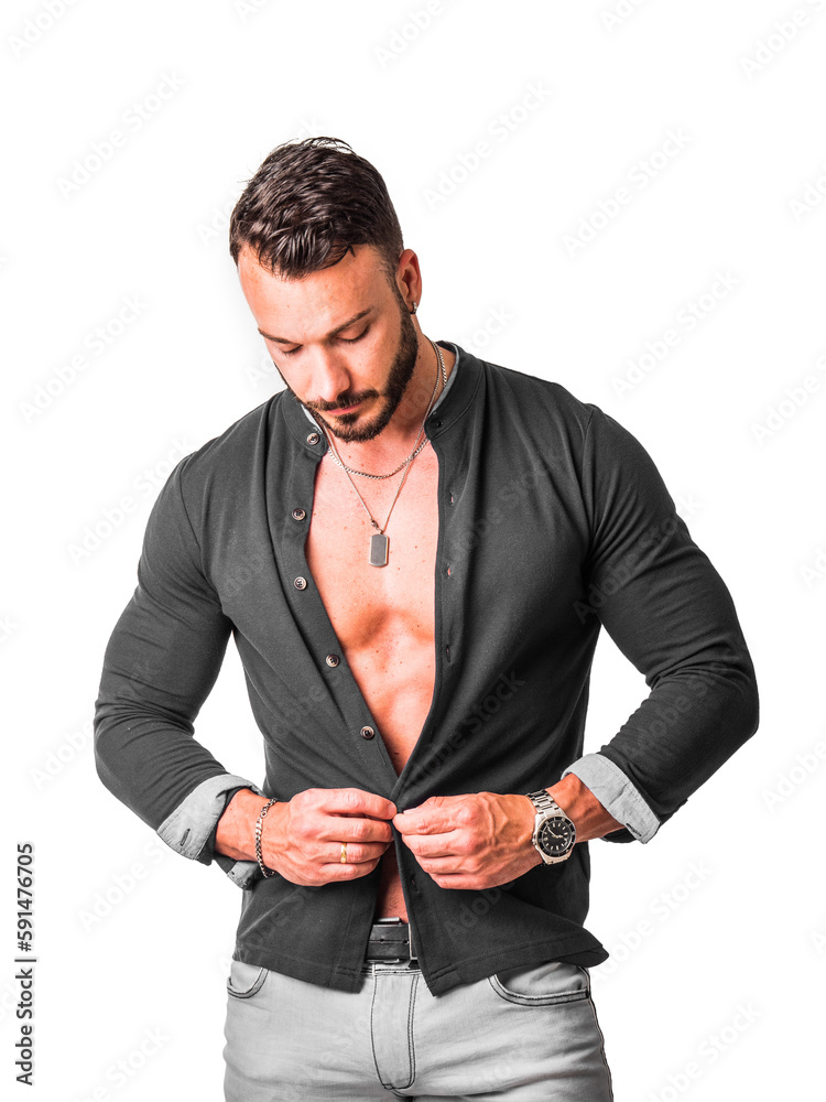 Handsome young muscular man taking off shirt Stock Photo | Adobe Stock