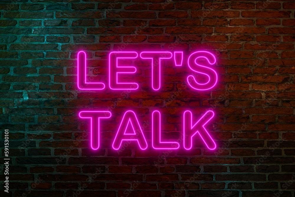 Let's talk. Neon sign. Brick wall at night with the text "Let's talk ...