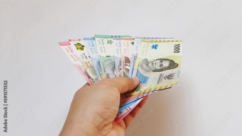 Hand holding showing indonesia rupiah, new rupiah money series ...