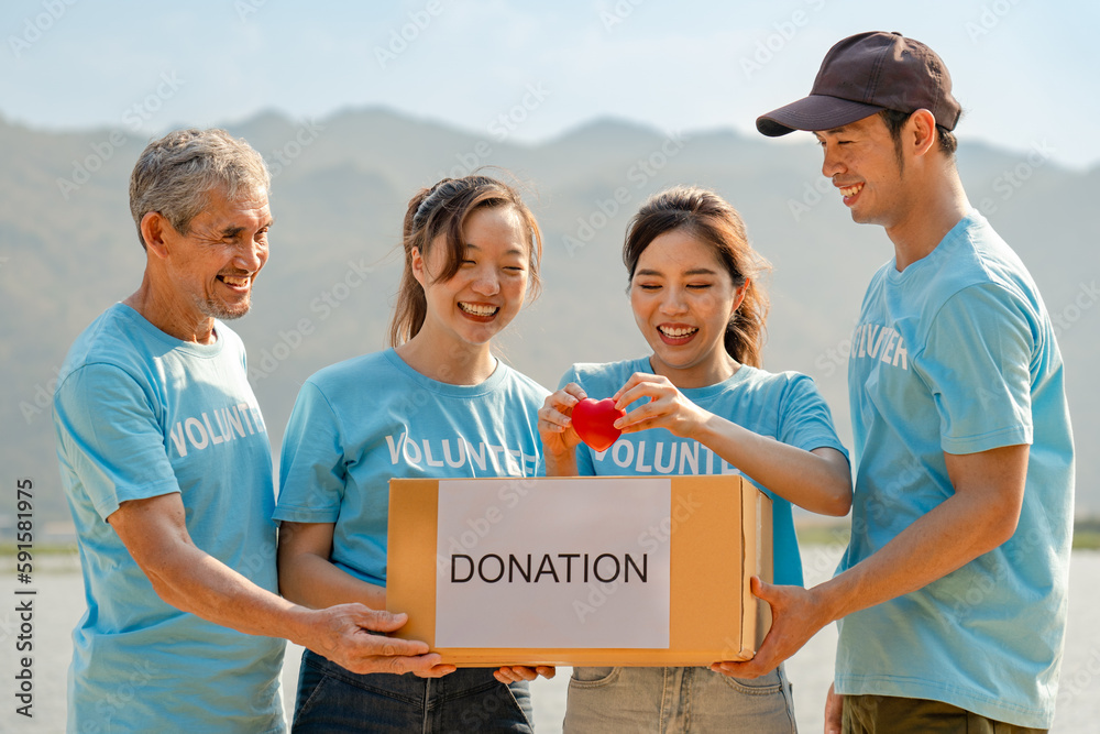 Group Of Diverse Volunteers Carrying Donation Box And A Red Heart group-of-diverse-volunteers-carrying-donation-box-and-a-red-heart