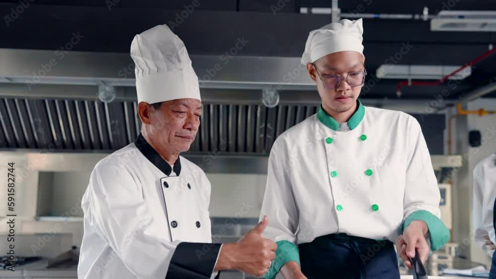 4K, Main chef in this kitchen standing explaining cooking students ...