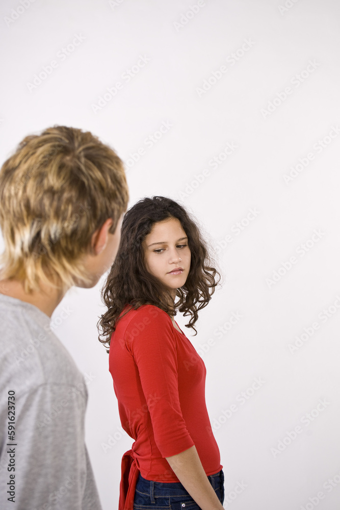 Teenage Girl Looking Disdainfully at Teenage Boy Stock Photo | Adobe Stock