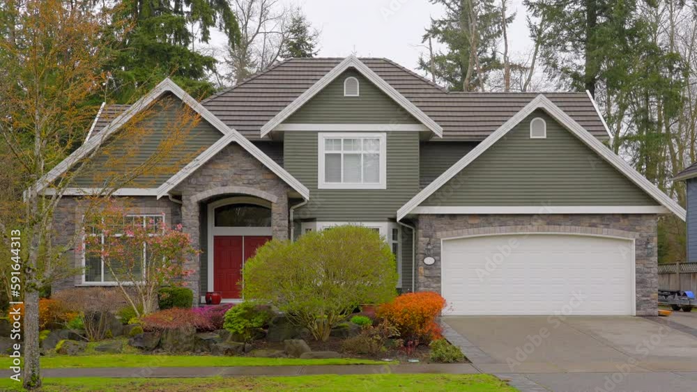 Establishing shot of two story stucco luxury house with big tree and ...