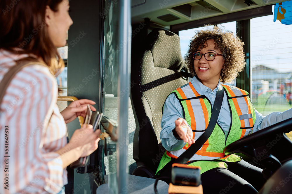 Happy female driver talks to commuter in public bus. Stock Photo ...