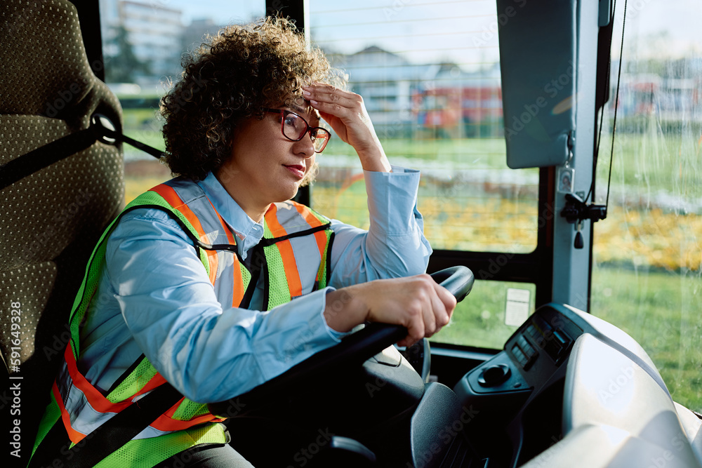 Female bus driver having headache while sitting behind steering wheel ...