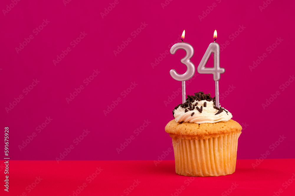 Birthday cake with candle number 34 - Rhodamine Red foamy background ...