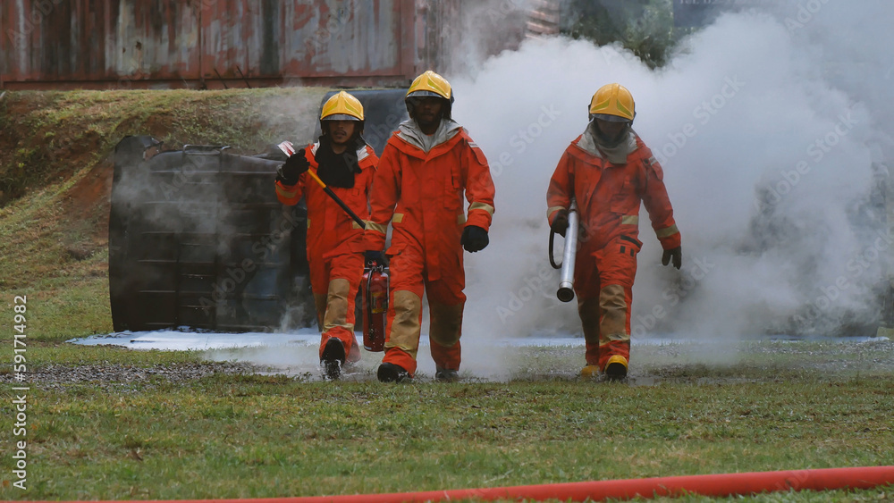 Firefighter Rescue team training in fire fighting extinguisher ...