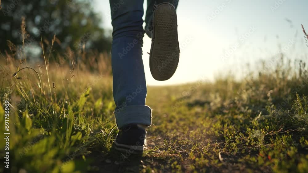 Child runs in nature in park. Close-up kid's feet on green grass ...
