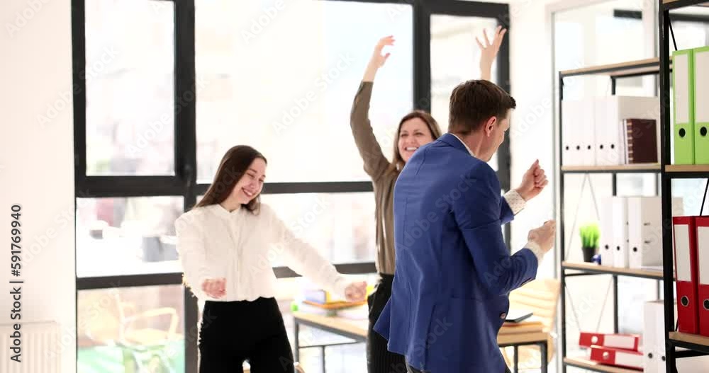 Happy colleagues in formal outfits enjoy dancing together in modern ...