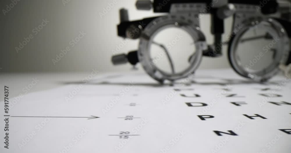 Ophthalmology goggles lie on white paper with Snellen chart letters in ...