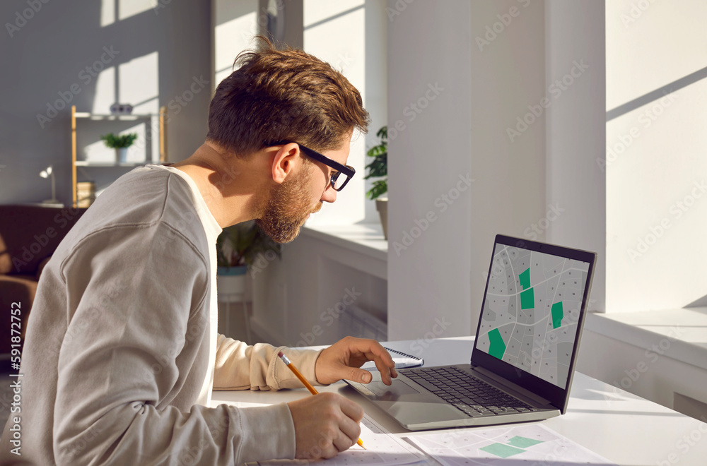 Side view portrait of professional cartographer working with cadastral ...