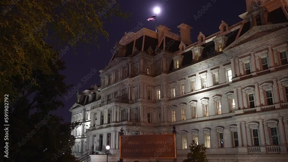Night time view of the Eisenhower old Executive Office Building next to ...