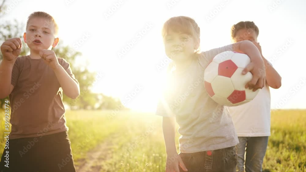 Children are walk in the park. A team of young athletes go to training ...