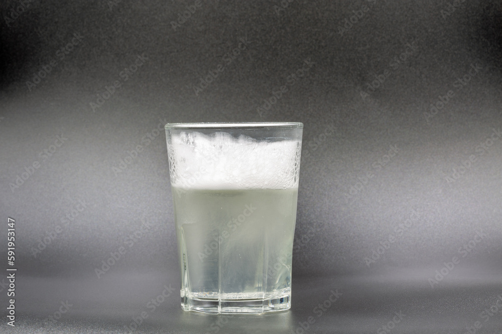 Dissolving instant effervescent tablets in a glass of water closeup ...