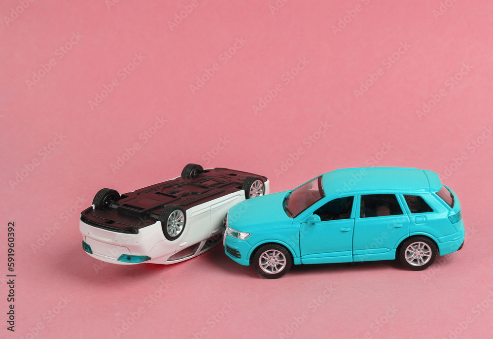 Two mini toy car crash on pink background, incident, car traffic ...