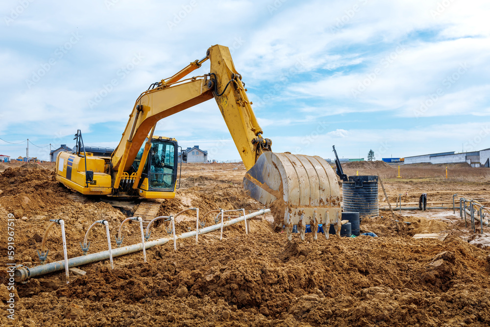 Excavator dig the trenches at a construction site. Trench for laying ...