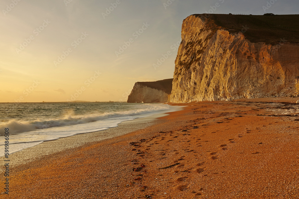 Footprints in the sand and Limestone cliffs near Durdle Door looking ...
