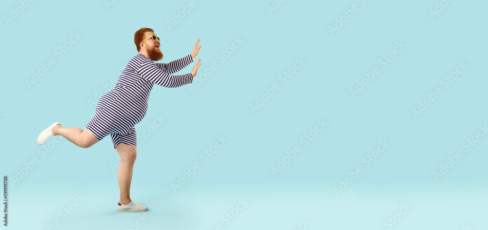 Profile view of funny fat man in striped retro swimsuit and sunglasses ...