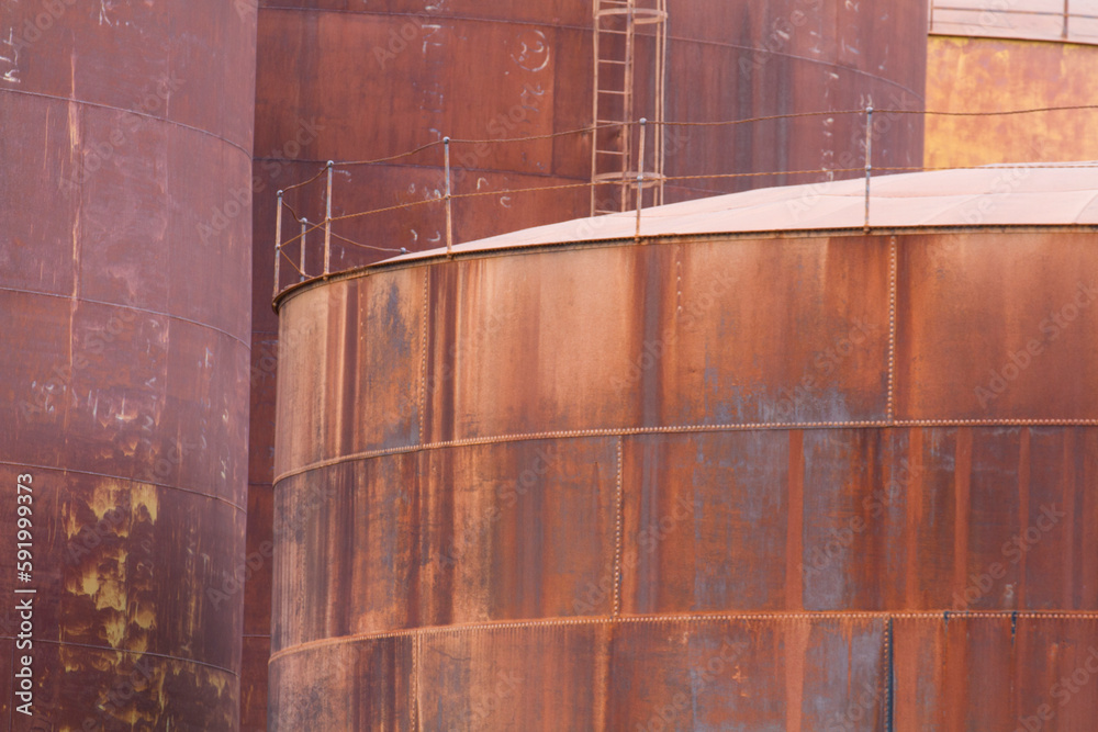 Rusty riveted storage tanks at the abandoned Stromness whaling station ...