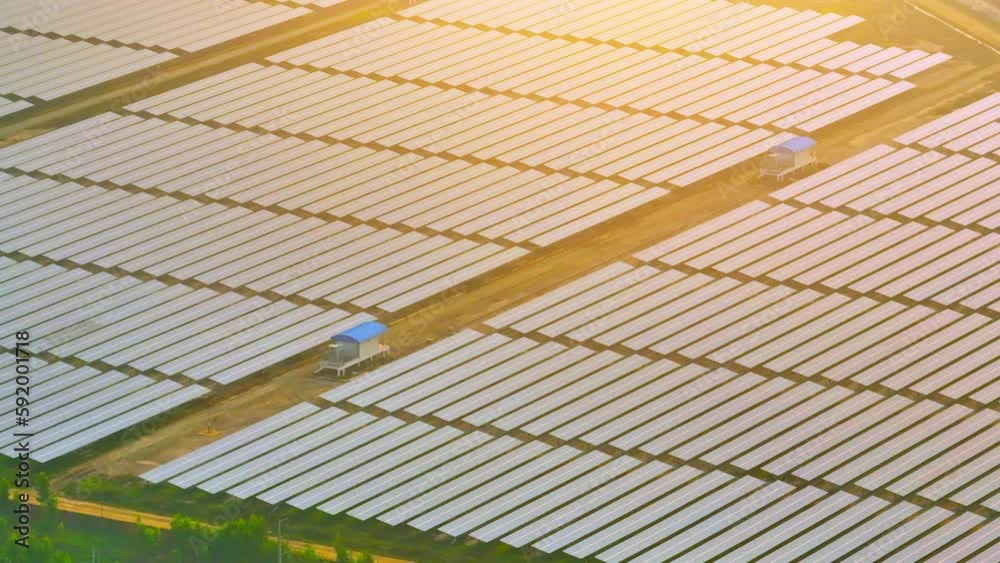 A sprawling solar power plant with rows of glistening solar panels ...