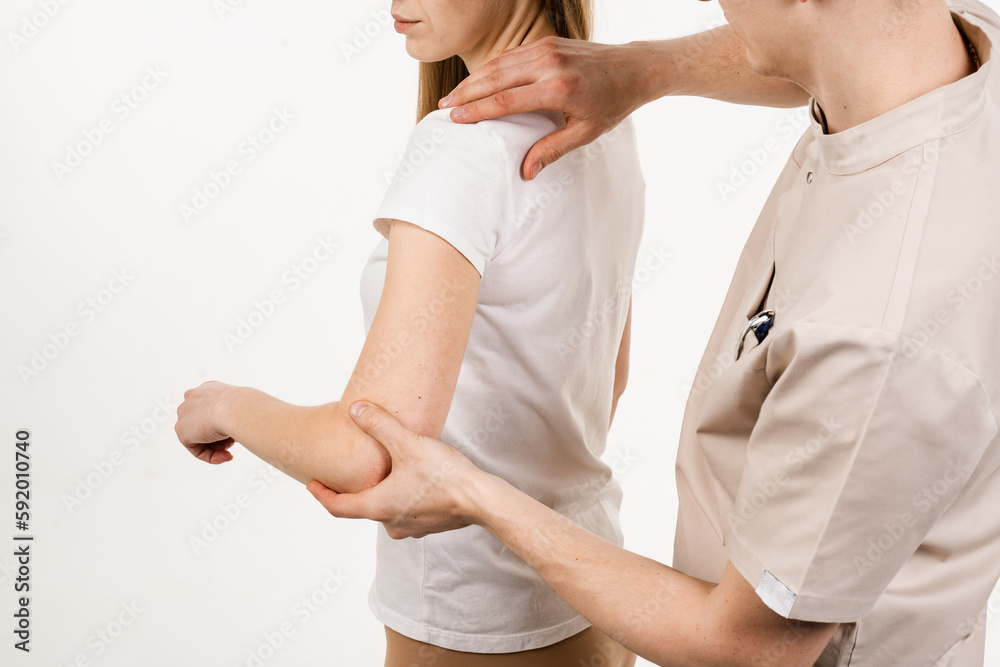 Orthopedic traumatologist examines shoulder joint of patient and checks ...