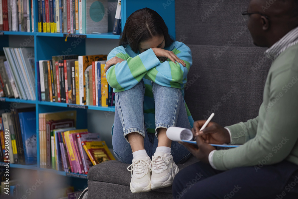 Portrait of stressed teenage girl crying in mental health therapy ...