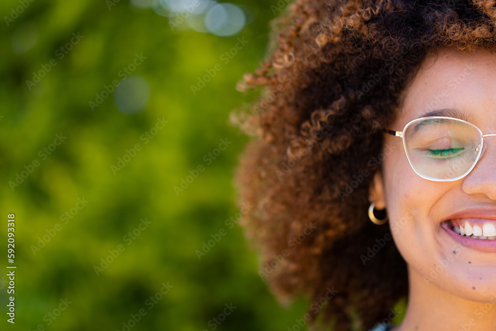 Cropped face of biracial young woman with eyes closed and afro hair ...