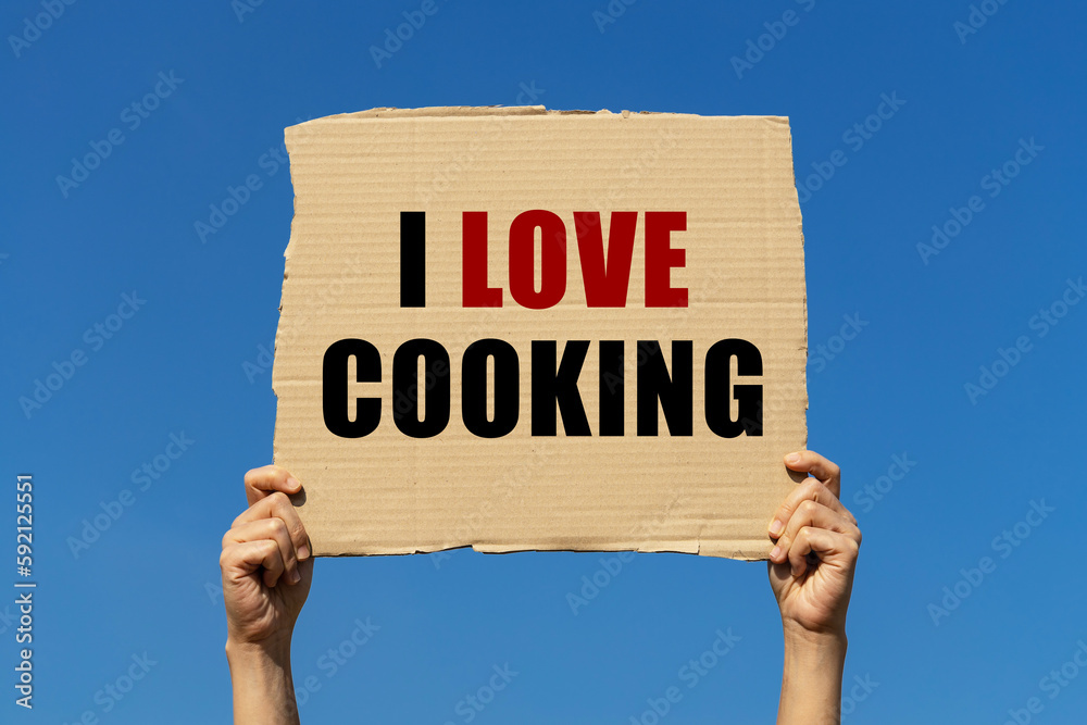 I love cooking text on box paper held by 2 hands with isolated blue sky ...