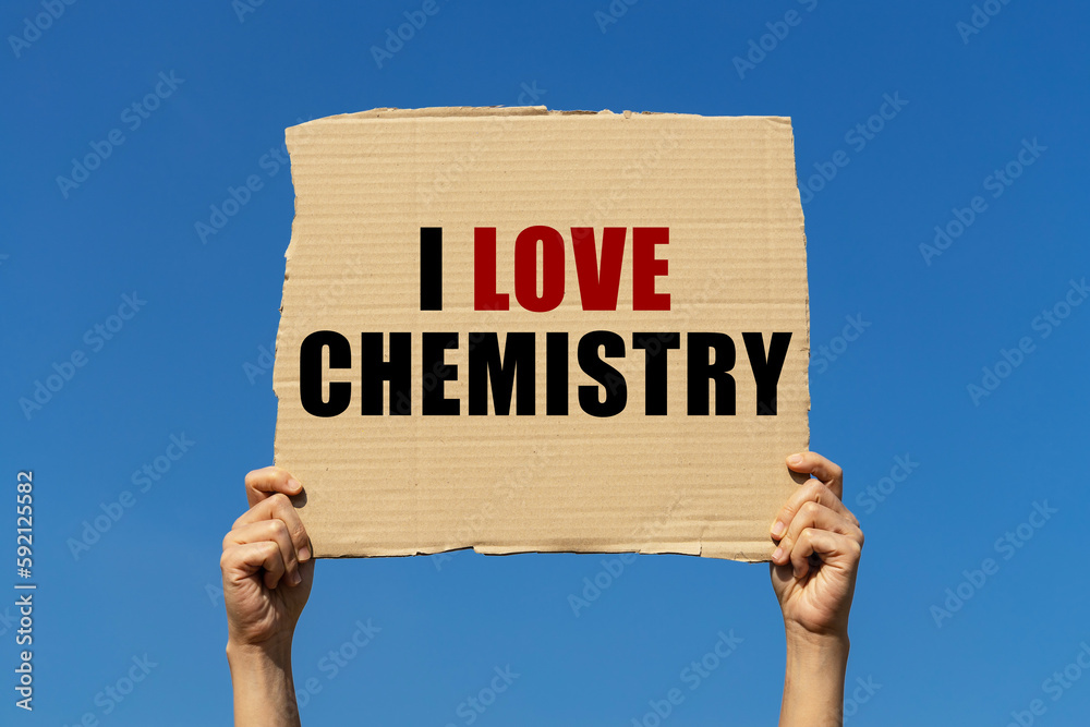 I love chemistry text on box paper held by 2 hands with isolated blue ...