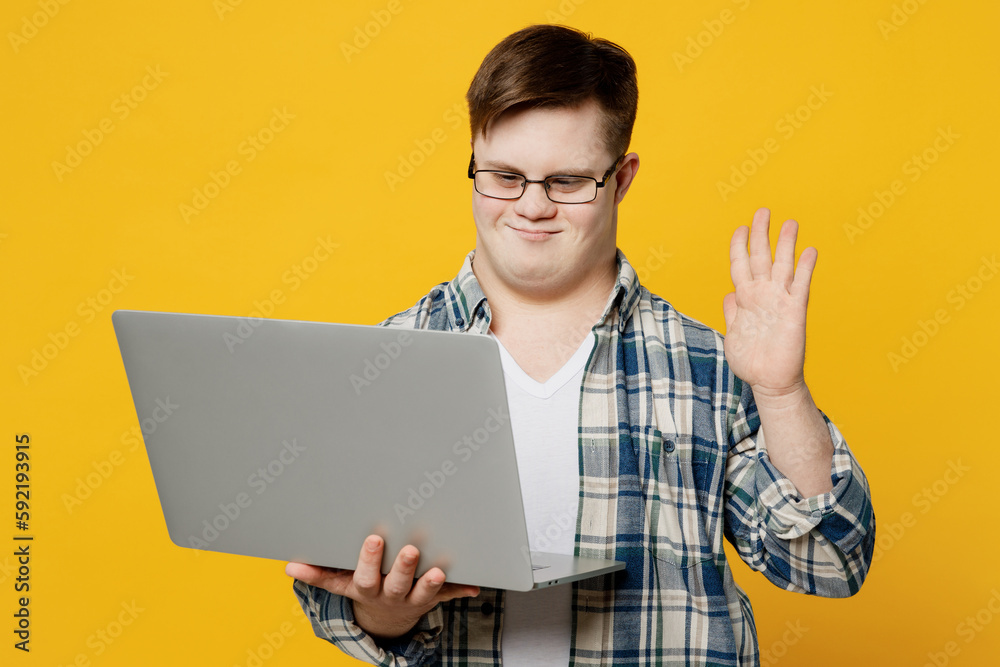Young smiling IT man with down syndrome wear glasses casual clothes ...