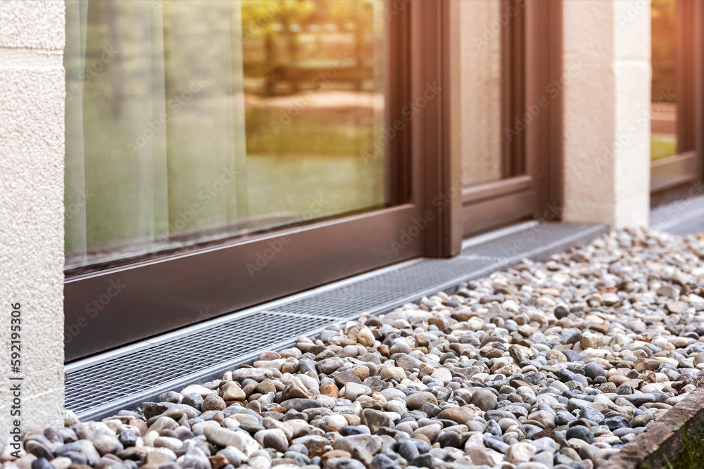 Foto Stock French Drain covered with Drainage Rocks and Grid. Drainage ...