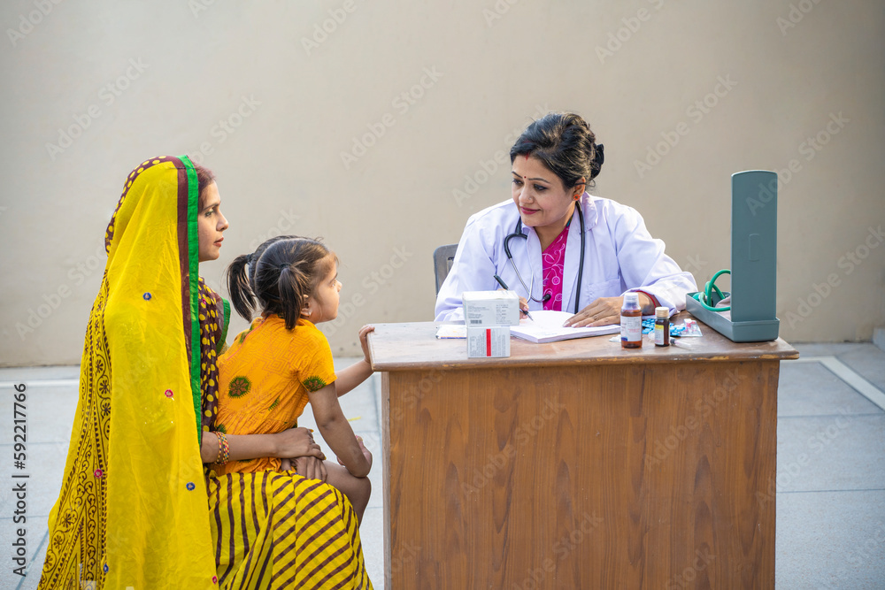 Indian female doctor checking little child patient at village. Stock ...