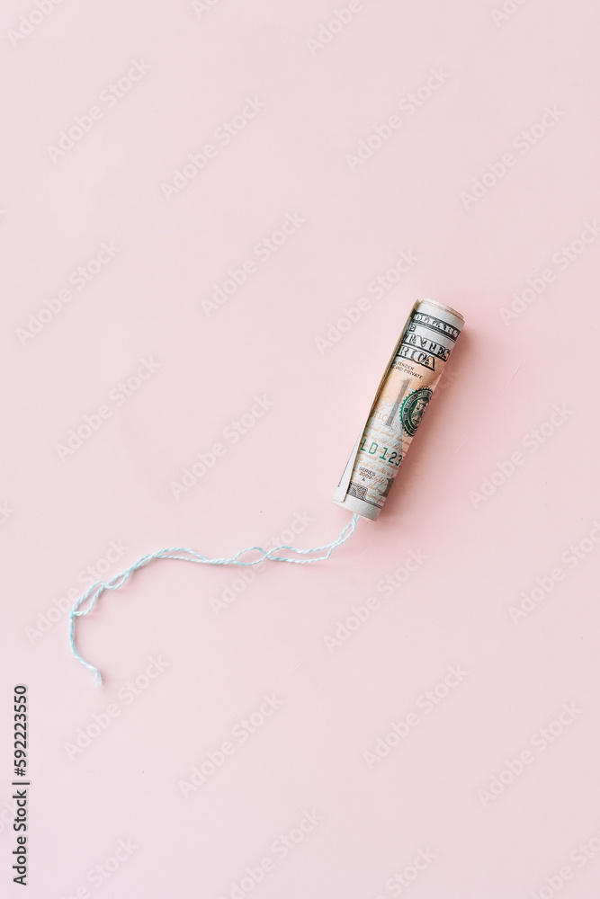 Tampon wrapped in hundred dollar bill on pink background. Stock Photo ...