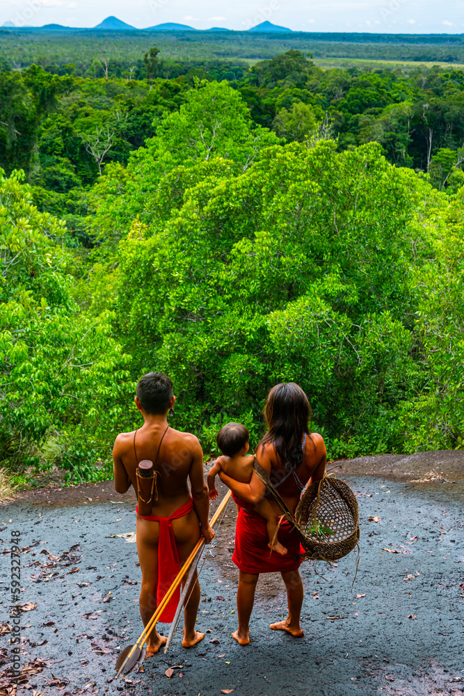 Foto de Couple with their child, standing on a giant rock, Yanomami ...