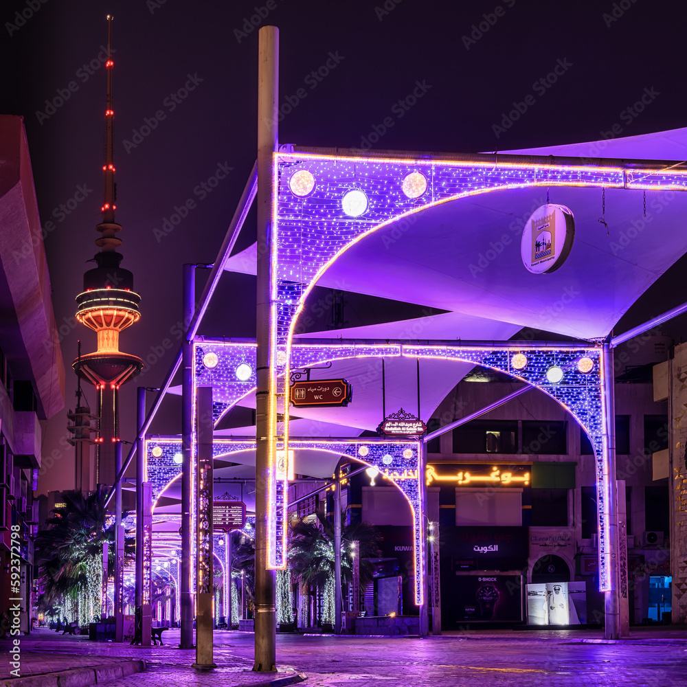 Shot of a purple lighten shopping street with the Liberation Tower at ...