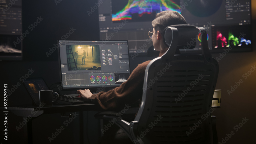 Female editor works in modern studio on computer using professional ...