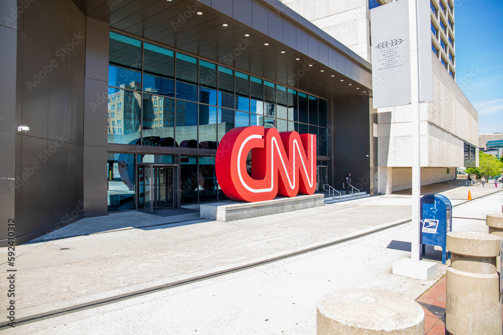 The front of the CNN Center with the red and white CNN logo and people ...