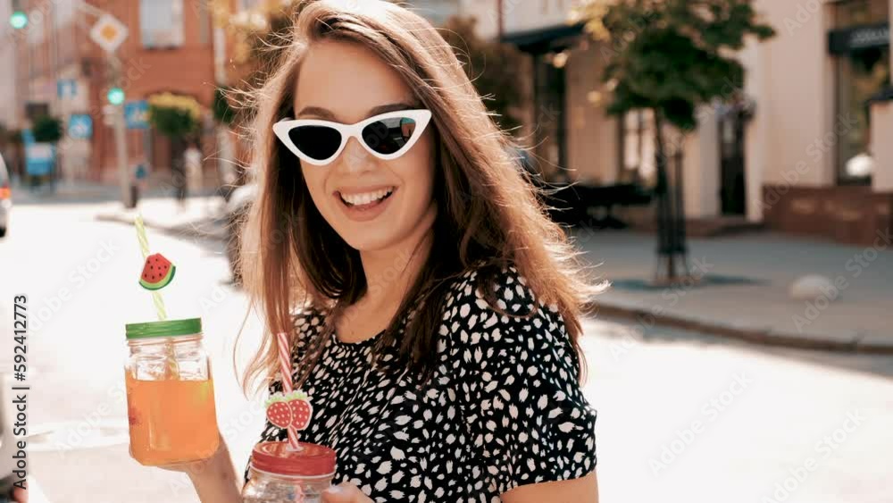 Young beautiful smiling hipster woman in sunglasses. Girl in summer trendy clothes posing in the ...