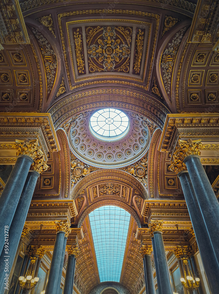 Achitectural details with the glass ceiling and golden ornaments inside ...