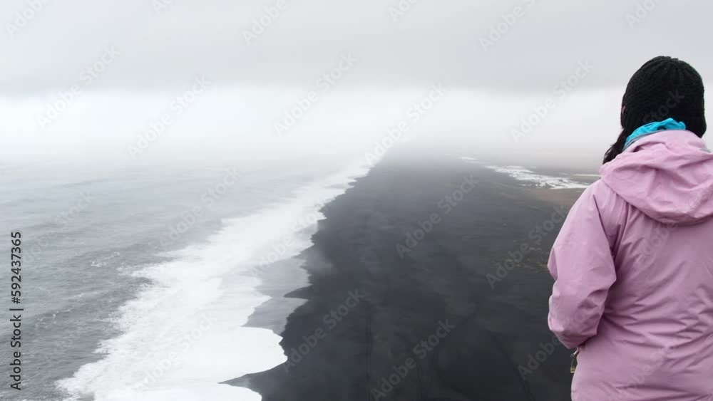 Single woman tourist stand thoughtful look at atlantic ocean waves ...