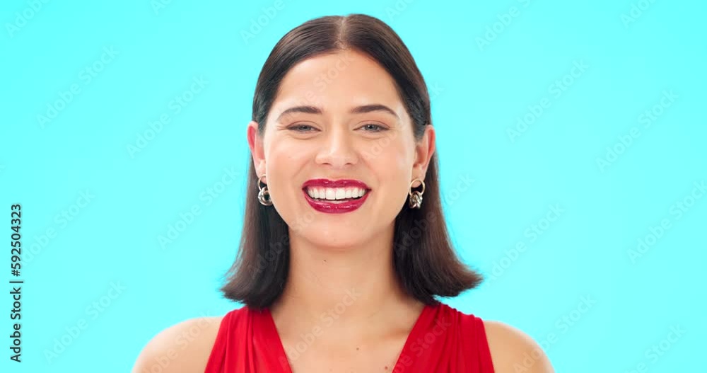 Happy, woman and winking face on blue background, studio and color ...