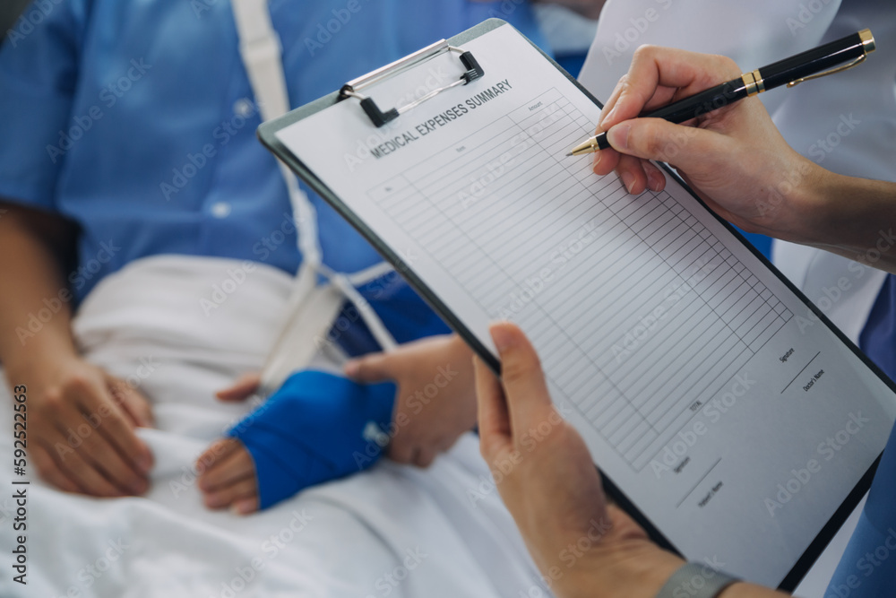 Injured patient showing doctor broken wrist and arm with bandage in ...